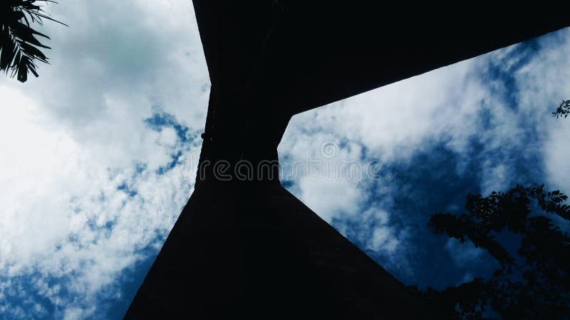 View of Sky Under a Bell Tower with White Clouds and Silhouette of ...