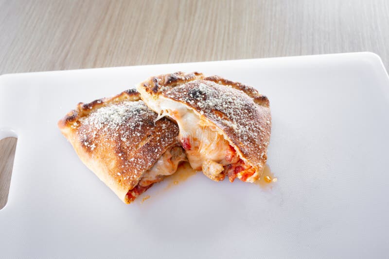 Sliced open calzone stock photo. Image of parmesan, slice - 281144926