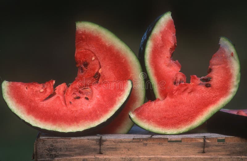 View of Sliced Ripe Watermelons on a Wooden Surface with a Black ...