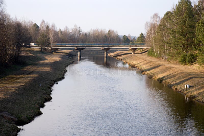 View of a Small River with a Bridge in Spring. Channel of the Vileyka ...