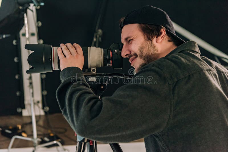 Emotional Cameraman with Retro Camera in His Hands, Studio Shot. Old ...