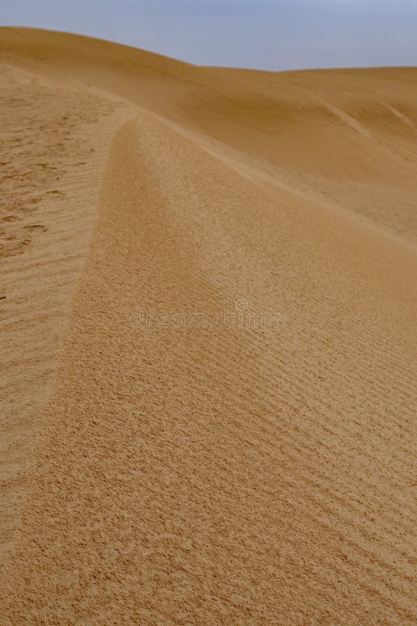 A View of a Smooth Desert Dune Against a Blue Sky Stock Photo - Image ...