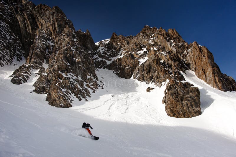 View at Snowboarder Sliding Down the Mountain Side Stock Photo - Image ...