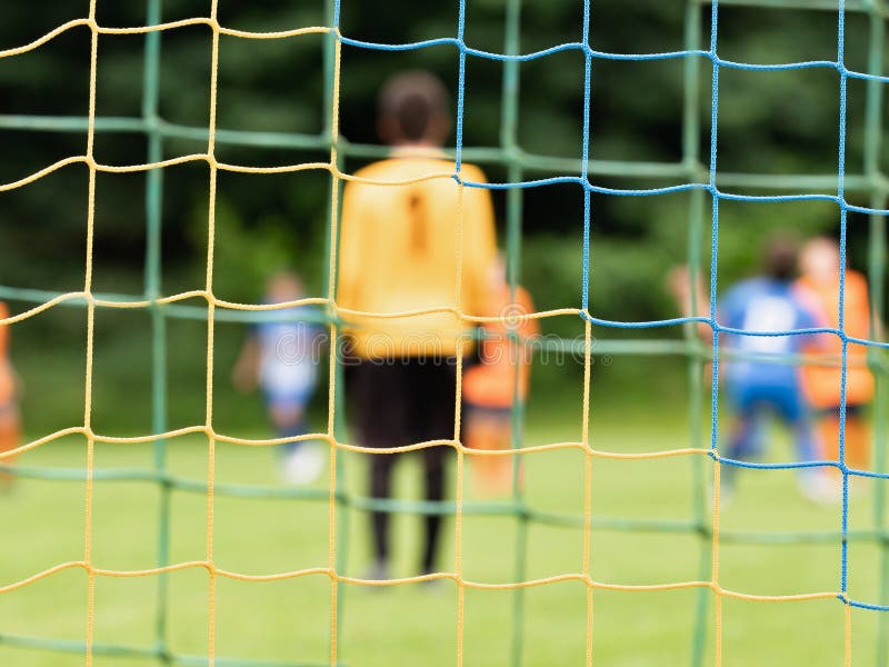 View through Soccer Gate Net. the Goalkeeper Slowly Backs Up during the ...