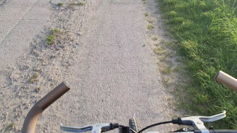 View of the Steering Wheel of a Moving Bicycle with the Asphalt Road ...