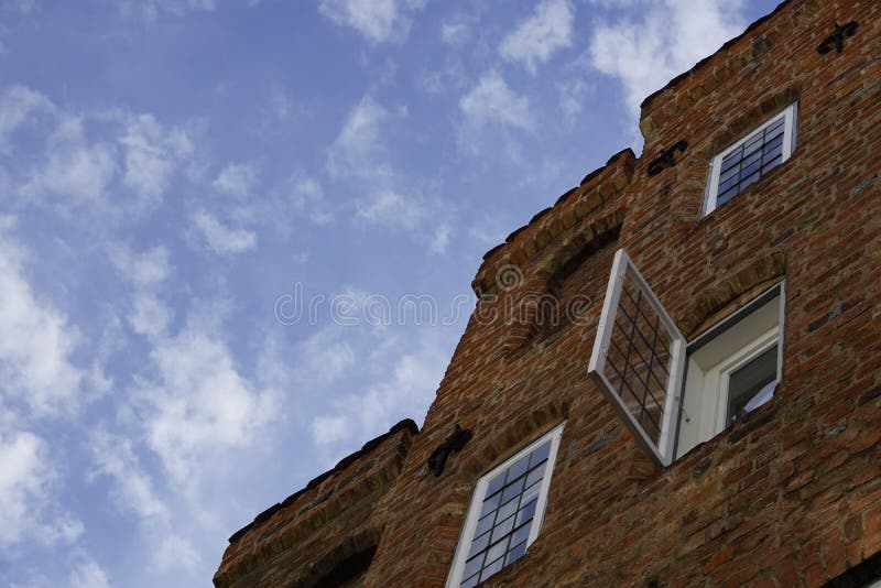 View of a Stepped Roof Building with a Brick Wall and Small Windows ...