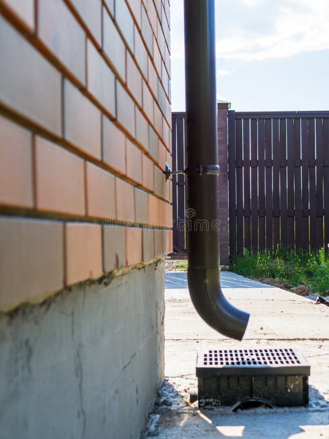 View of the Storm Drain Pipe Installed on the Brick Wall of a Private ...