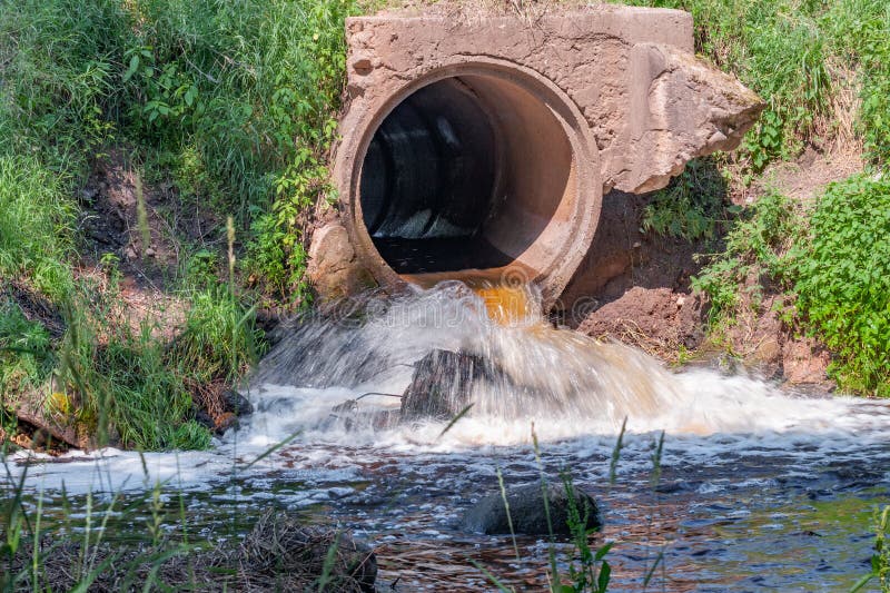 A View of the Stormy Flow of Clear Water from the Culvert on a Bright ...