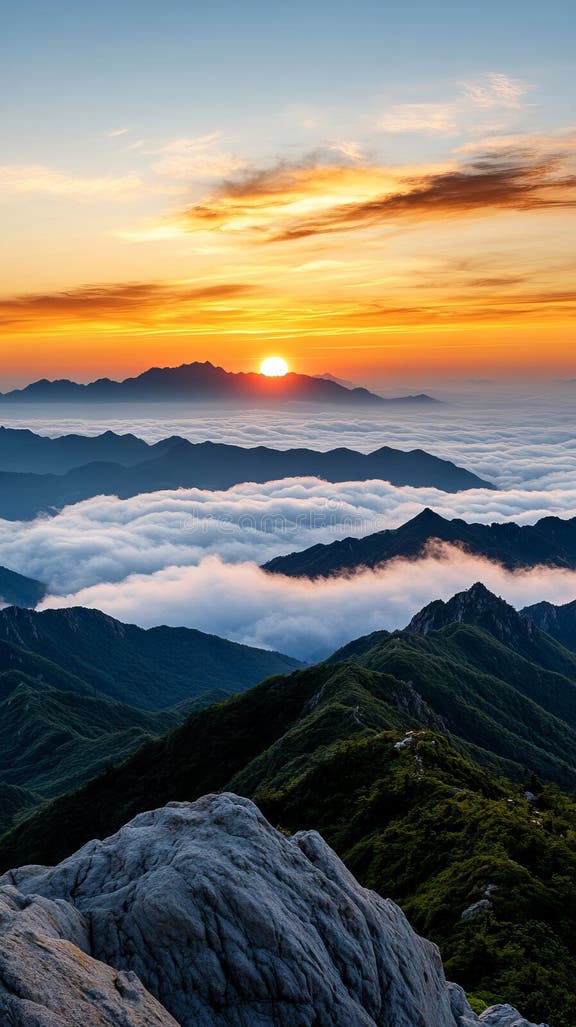 A View of the Sun Setting Over the Mountains from the Top of a Mountain ...