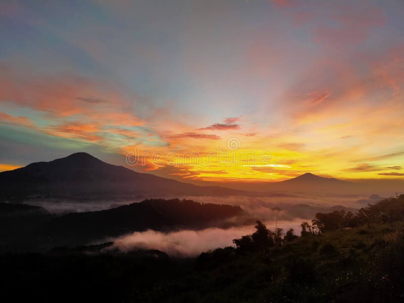 View of Sunrise Shining on Two Mountains Stock Photo - Image of sunrise ...