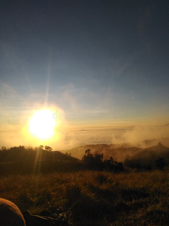 The Sun Rises on the Mountain Stock Photo - Image of sunrise, rises ...