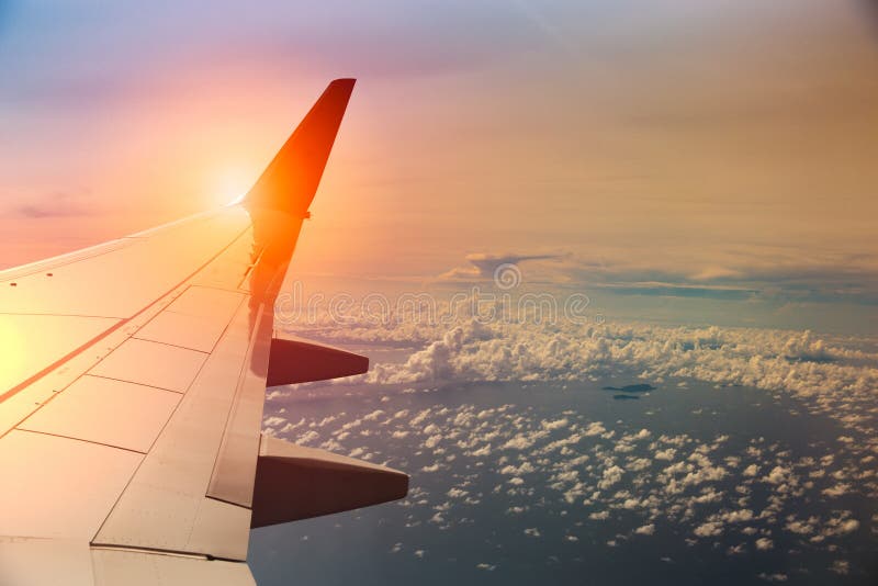 View on the Sunset and Airplane Wing from the Inside. Stock Image ...