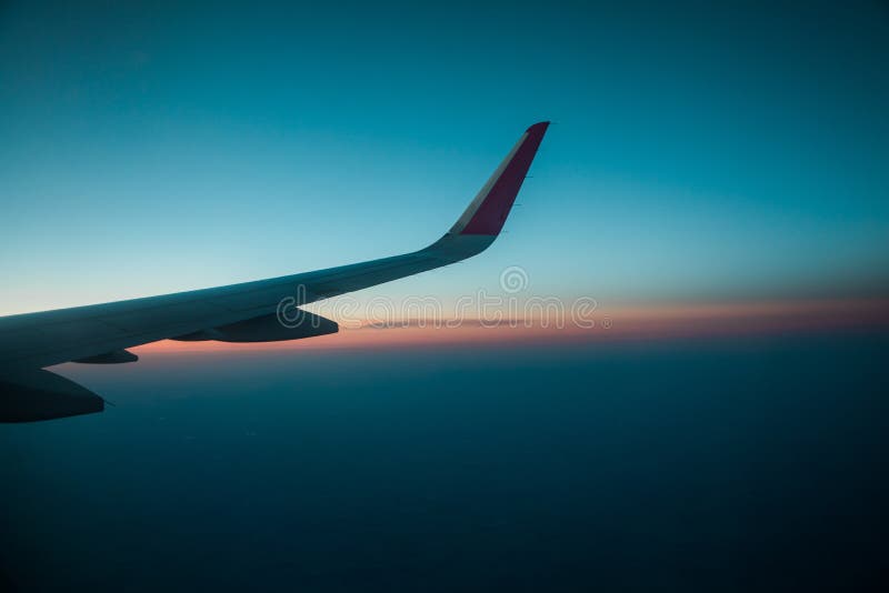 View on the Sunset and Airplane Wing from the Inside Stock Image ...