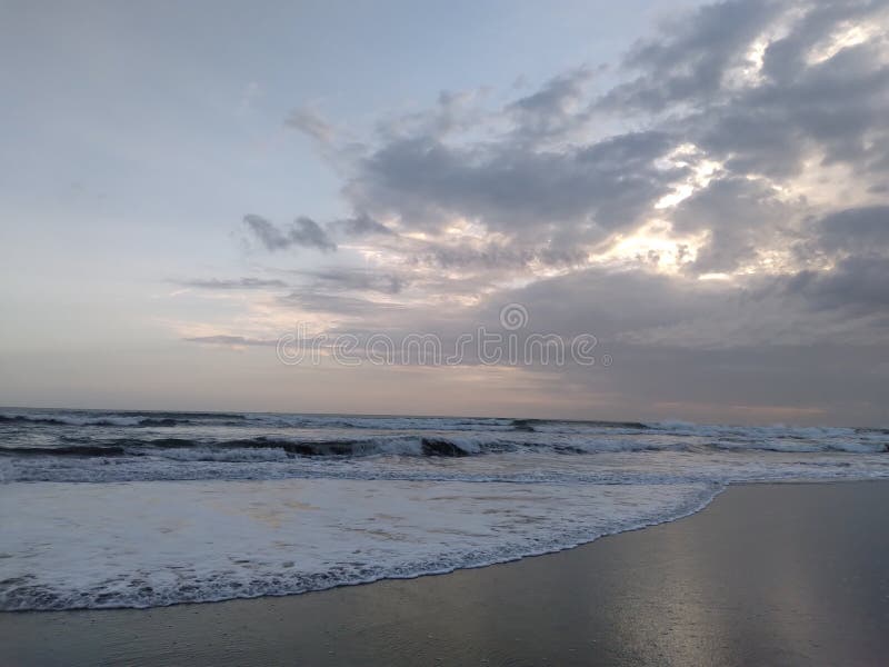 View of the Sunset on the Beach with Calm Waves and a Clear Sky ...