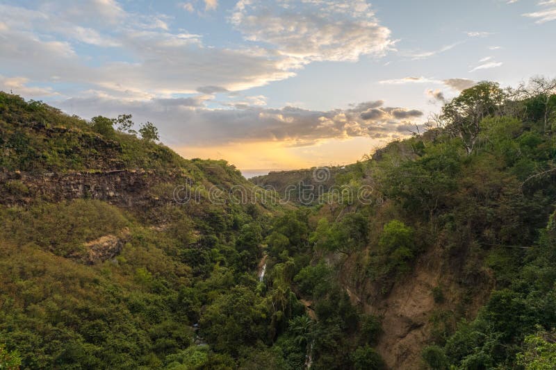 View of the Sunset from the Gorge of Mountains Covered with Green Grass ...