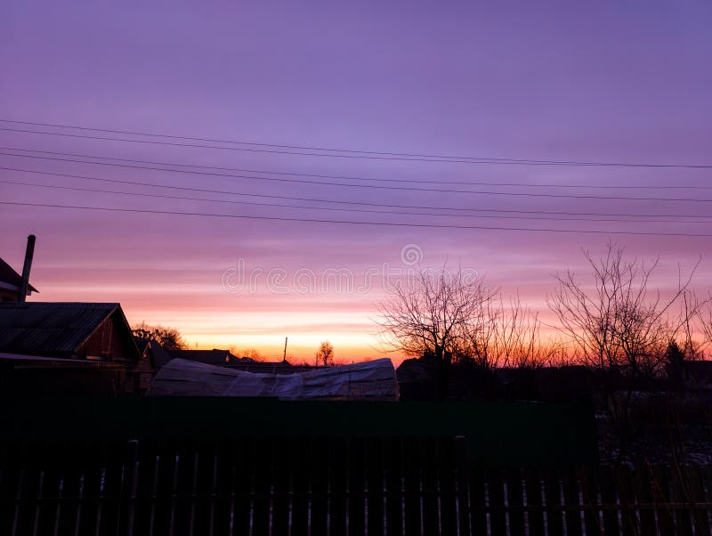 A View of a Sunset Over a Fence in a Backyard Stock Photo - Image of ...
