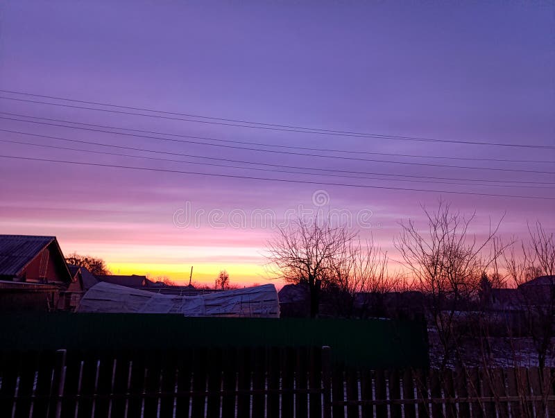 A View of a Sunset Over a Fence in a Backyard Stock Photo - Image of ...
