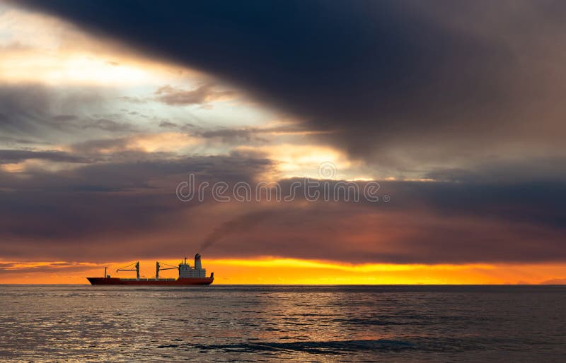 A Silhouette of a Cargo Ship at Sunset Stock Image - Image of horizon ...