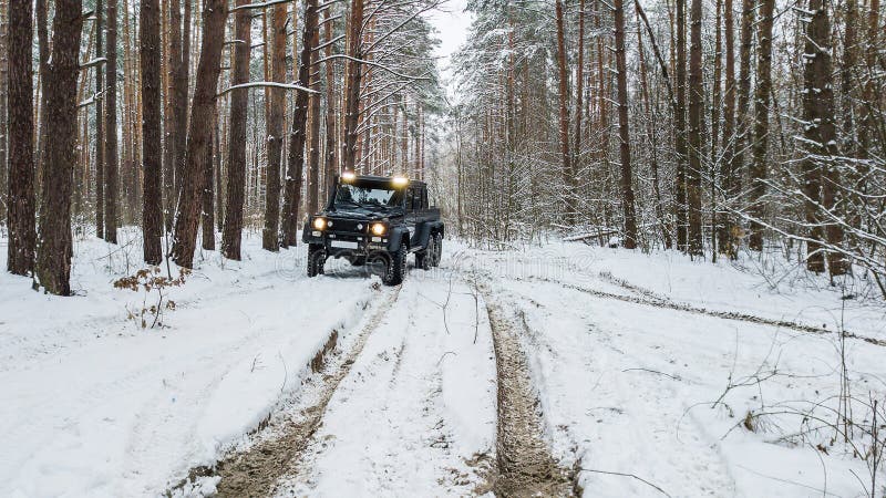 View on SUV 6x6 that Rides by Winter Road in Snow-covered Forest Stock ...