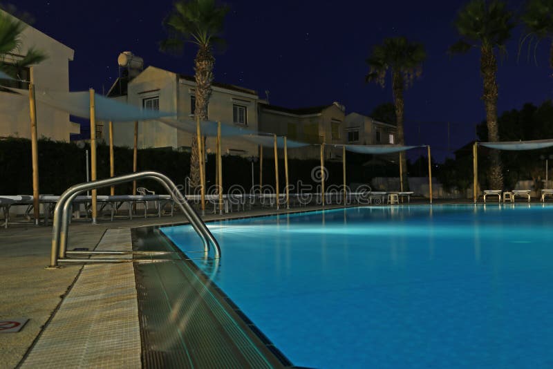 Swimming pool night scene stock image. Image of night - 99706063