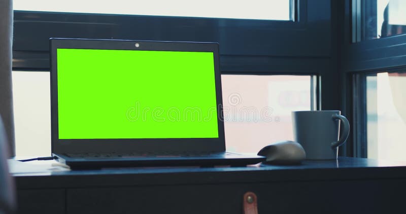 View of a Table with a Laptop Computer with a Green Screen. Stock Video ...
