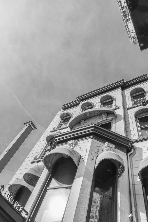 View of a Tall Building with Arches and Windows from Ground Level in ...