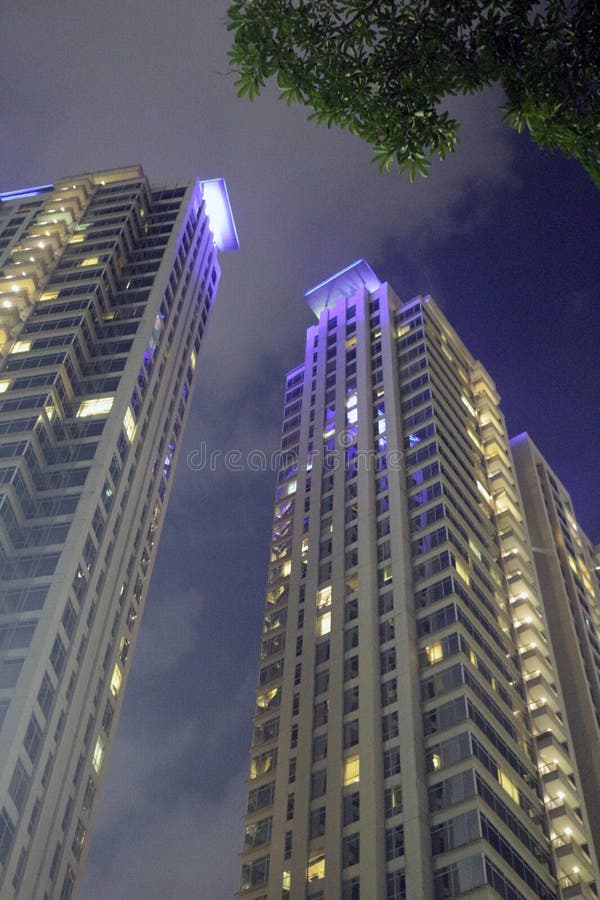 View of a Tall Building Filled with Lights from Below Stock Photo ...