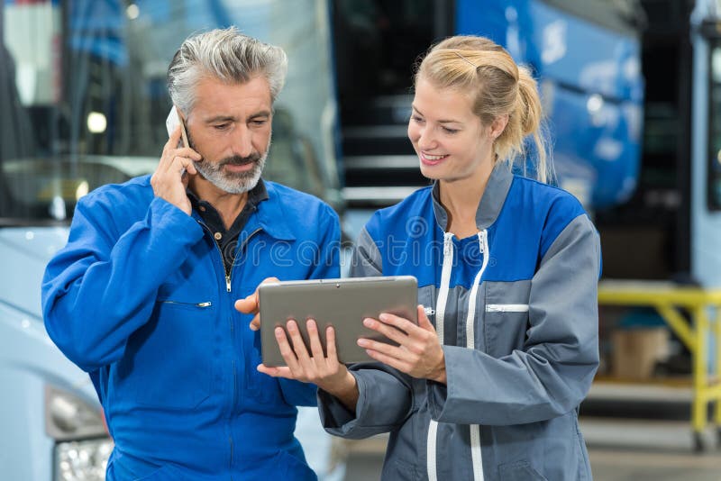View Team Mechanics Working at Garage Stock Image - Image of digital ...