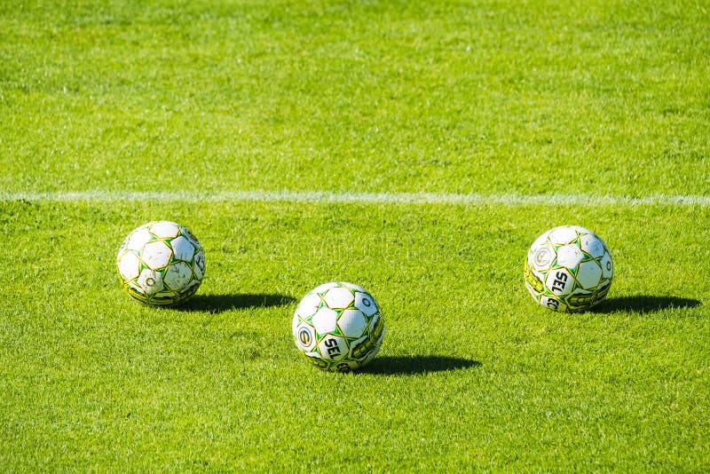 View of Three Footballs Lying on the Soccer Field Under the Sunlight ...
