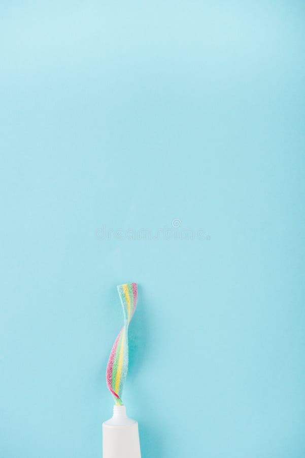 View of Toothpaste Tube with Chewing Candy Isolated on Blue with Copy ...