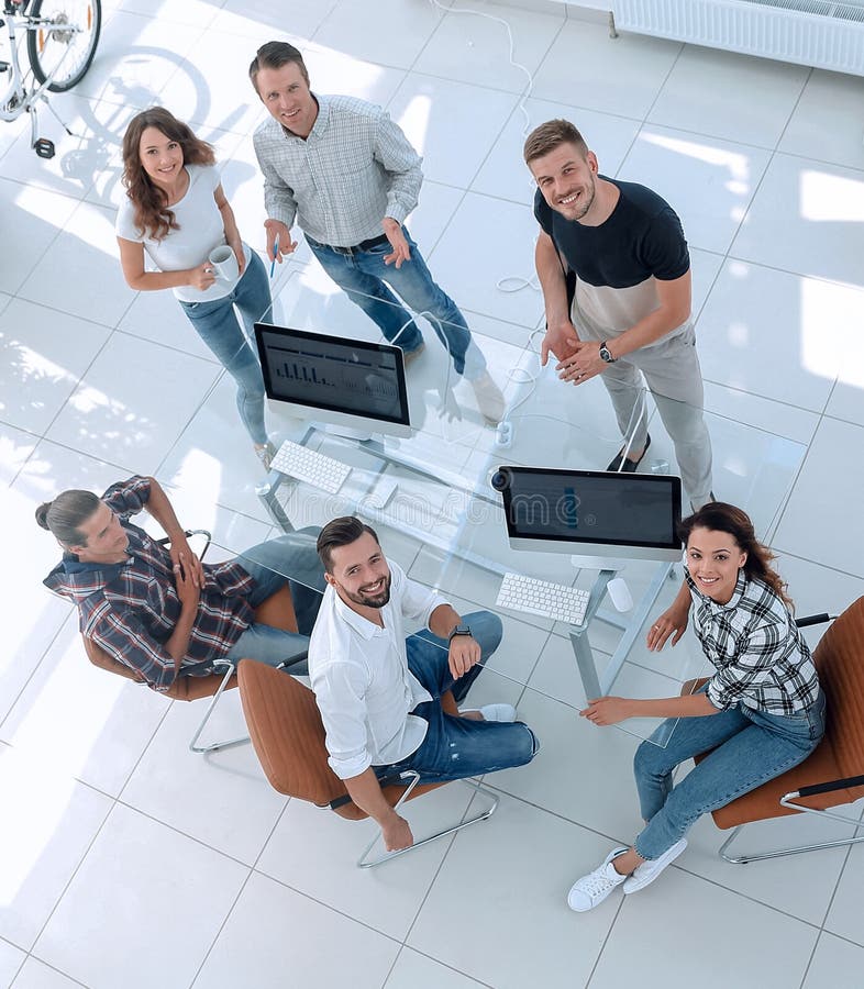 View the Top Creative Team Sitting Behind a Desk Stock Image - Image of ...