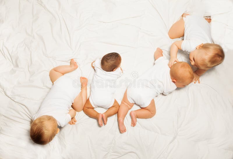 View from Top of Four Babies Backs Crawling in Row Stock Photo - Image ...