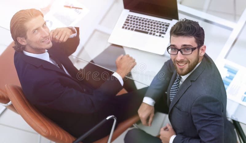 Successful Employees Sitting Behind a Desk Stock Photo - Image of graph ...
