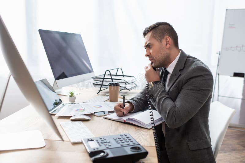 View of Trader in Grey Jacket Stock Photo - Image of laptop, handset ...