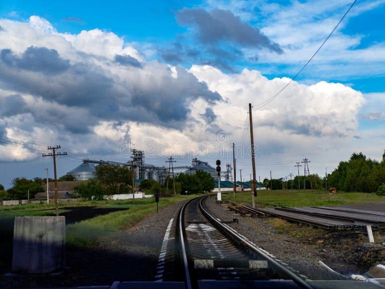 A View of a Train Track with a Factory in the Background Stock Photo ...