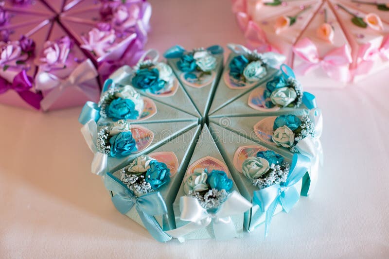 Triangle Sections of Cake Wrapped and Decorated Sitting on a Table ...