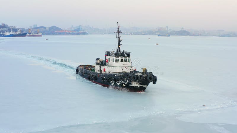 View of a Tug Making Its Way through the Ice at Sunset Stock Video ...