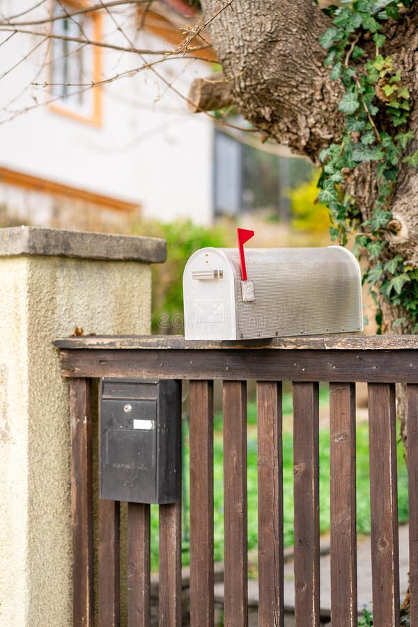View of Two Different Mailboxes Installed on the Fence of a Private ...
