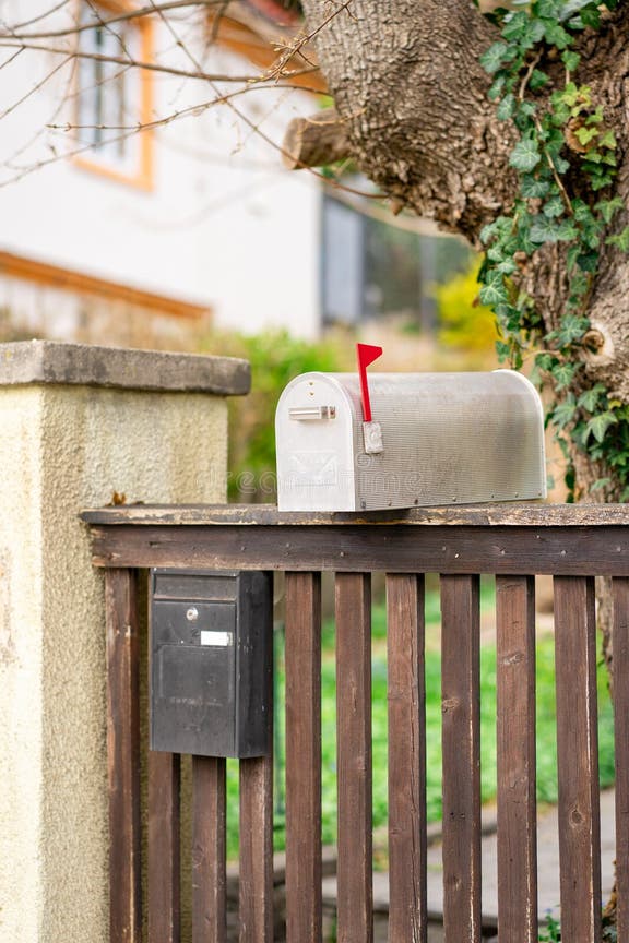 View of Two Different Mailboxes Installed on the Fence of a Private ...