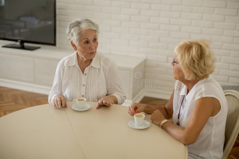 Two Older Women Drinking Coffe at Home and Talking Stock Image - Image ...