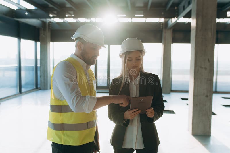View of Two Workers Working Outside with a Tablet on a Construction ...
