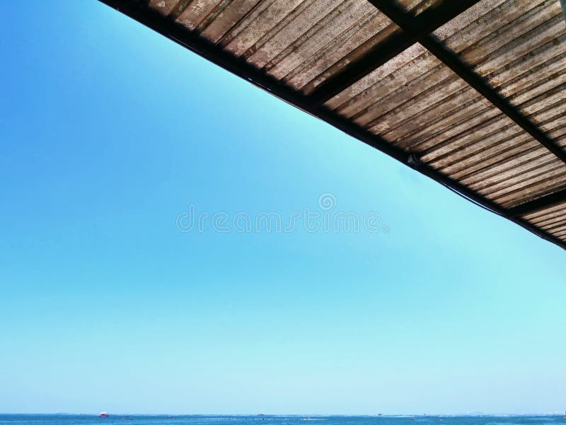 View Under the Roof with Blue Sea and Sky on Background Stock Photo ...