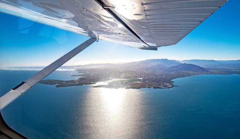 View from Under a Seaplane Wing Flying Over a Paradise Island Stock ...