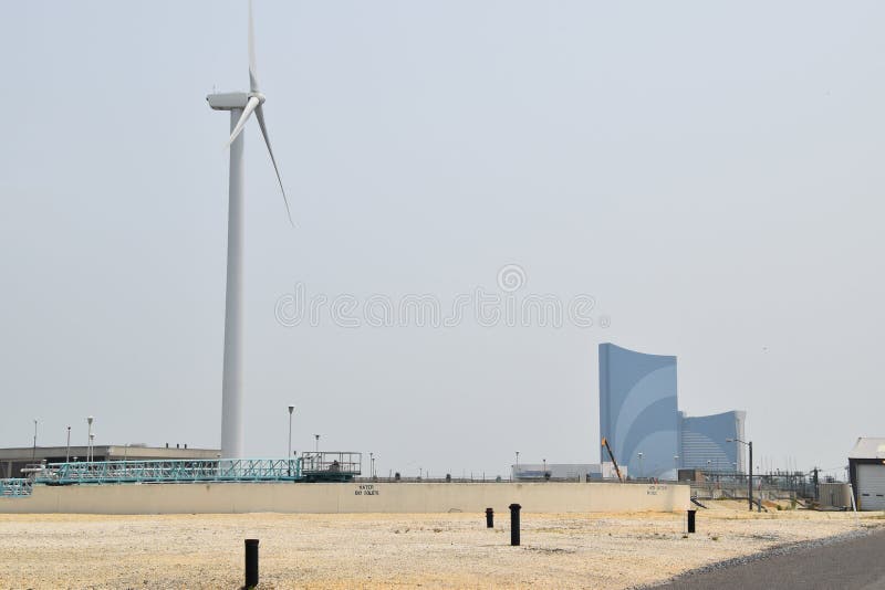 View from Underneath an Array of Solar Panels with a Farm Wind Turbine ...