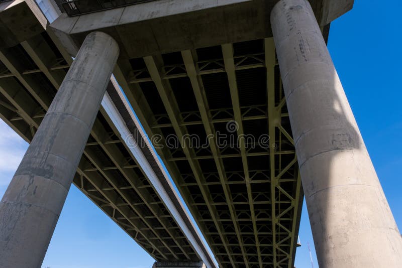 View Underneath a Large Bridge Highway on a Sunny Day with Blue Sky ...