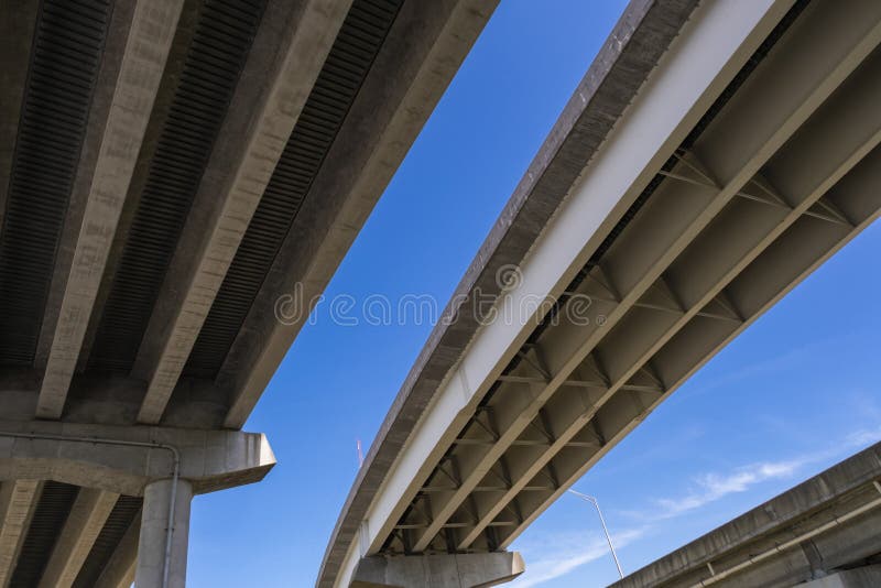 View Underneath a Large Bridge Highway on a Sunny Day with Blue Sky ...