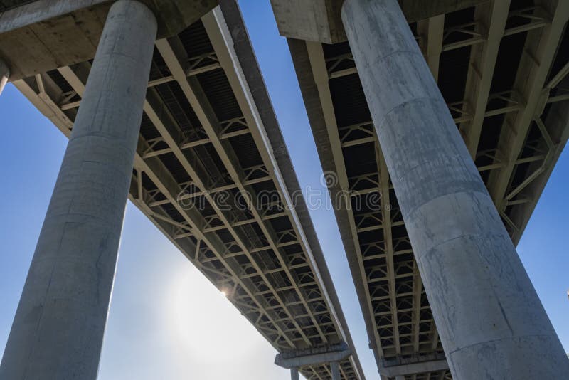 View Underneath a Large Bridge Highway on a Sunny Day with Blue Sky ...