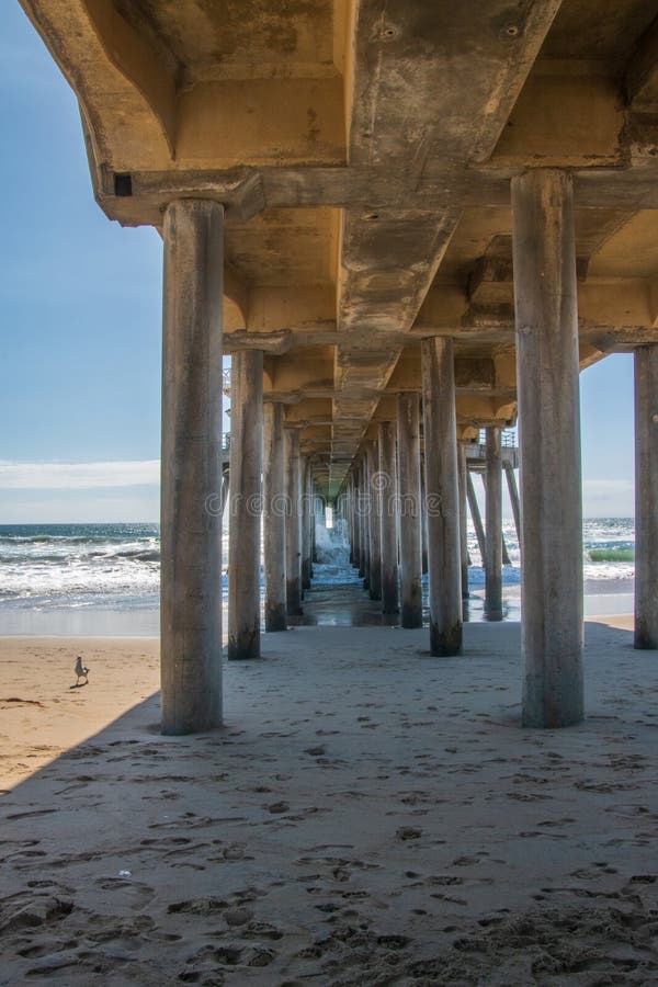 Concrete Pillars Underneath a Long Pier on the Beach Stock Photo ...