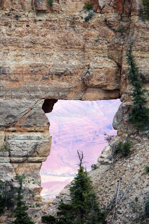 View of the Valley through a Triangle-shaped Crevice in a Large Rocky ...