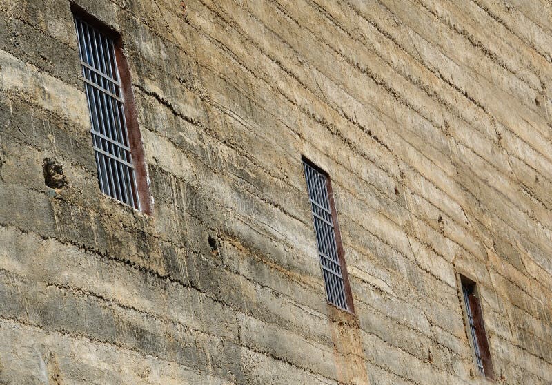 View of a Very Rustic Wall with Barred Windows Stock Photo - Image of ...